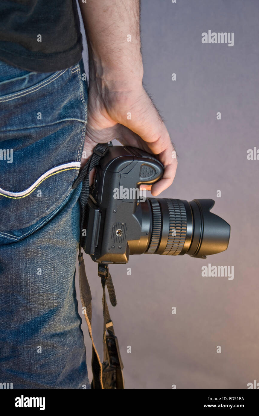 Image of male arm holding camera Stock Photo - Alamy
