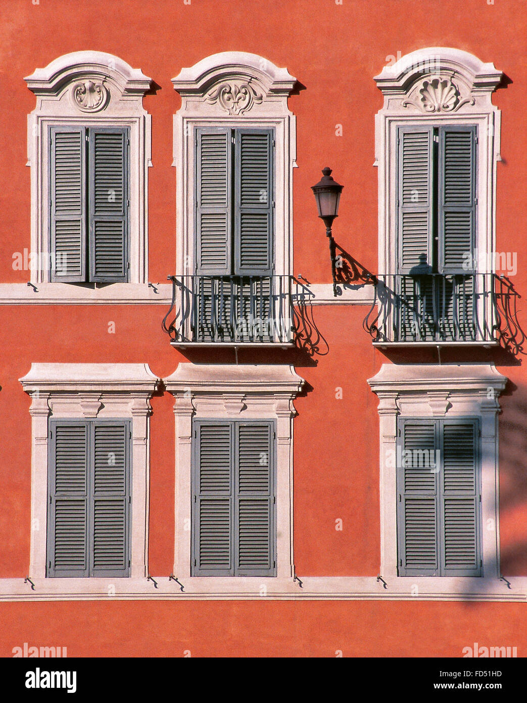 Beautiful Italian windows on red wall with balcony Stock Photo - Alamy
