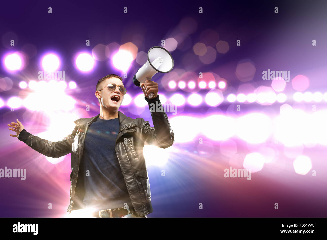 Image of young man musician singing in megaphone Stock Photo - Alamy