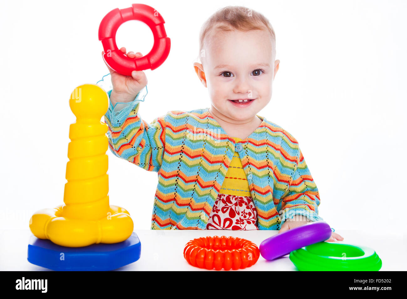Child building a colorful pyramid Stock Photo - Alamy