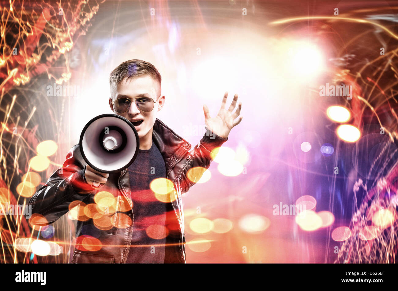 Image of young man rock musician screaming in megaphone Stock Photo - Alamy
