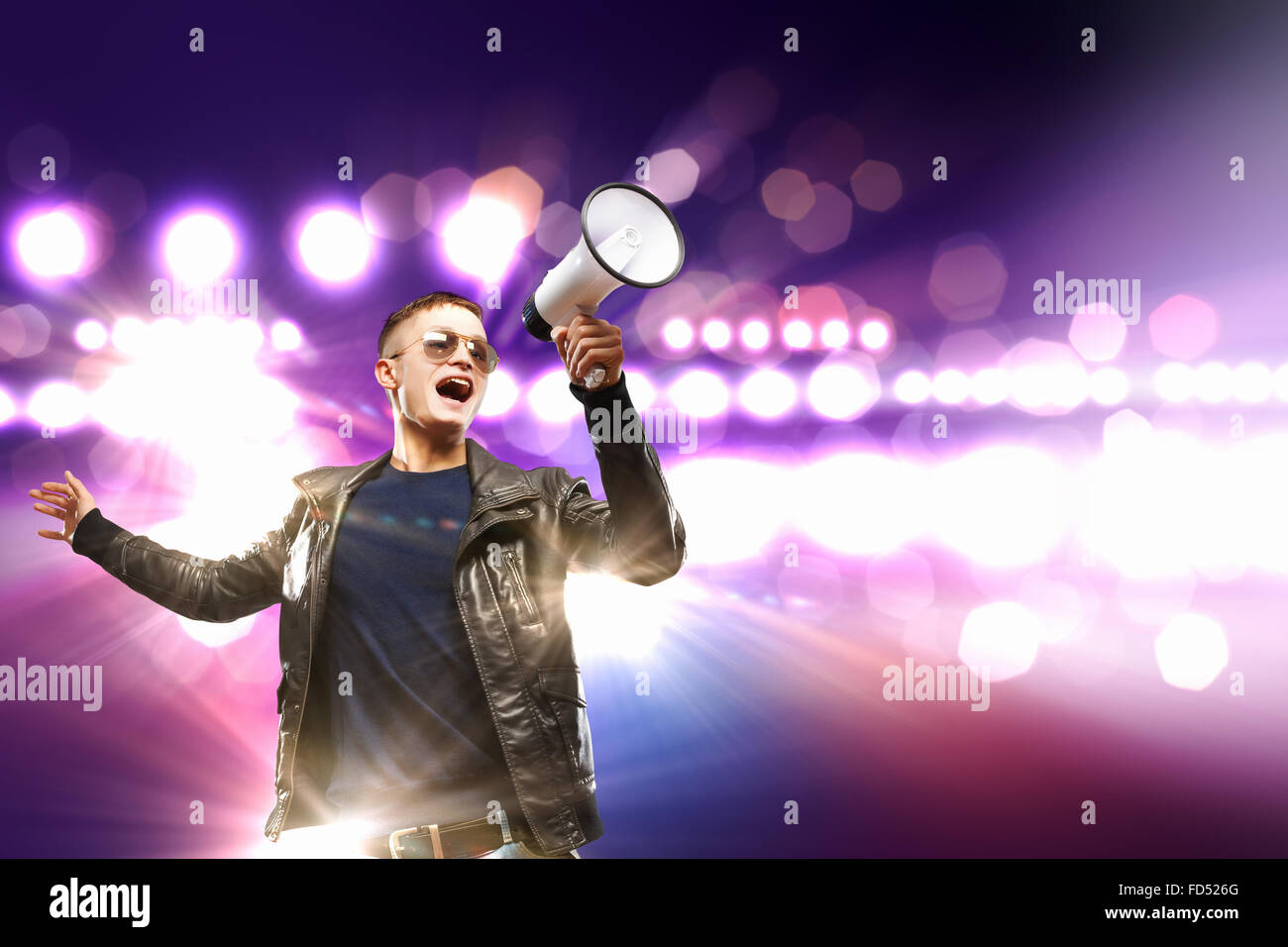 Image of young man rock musician screaming in megaphone Stock Photo - Alamy