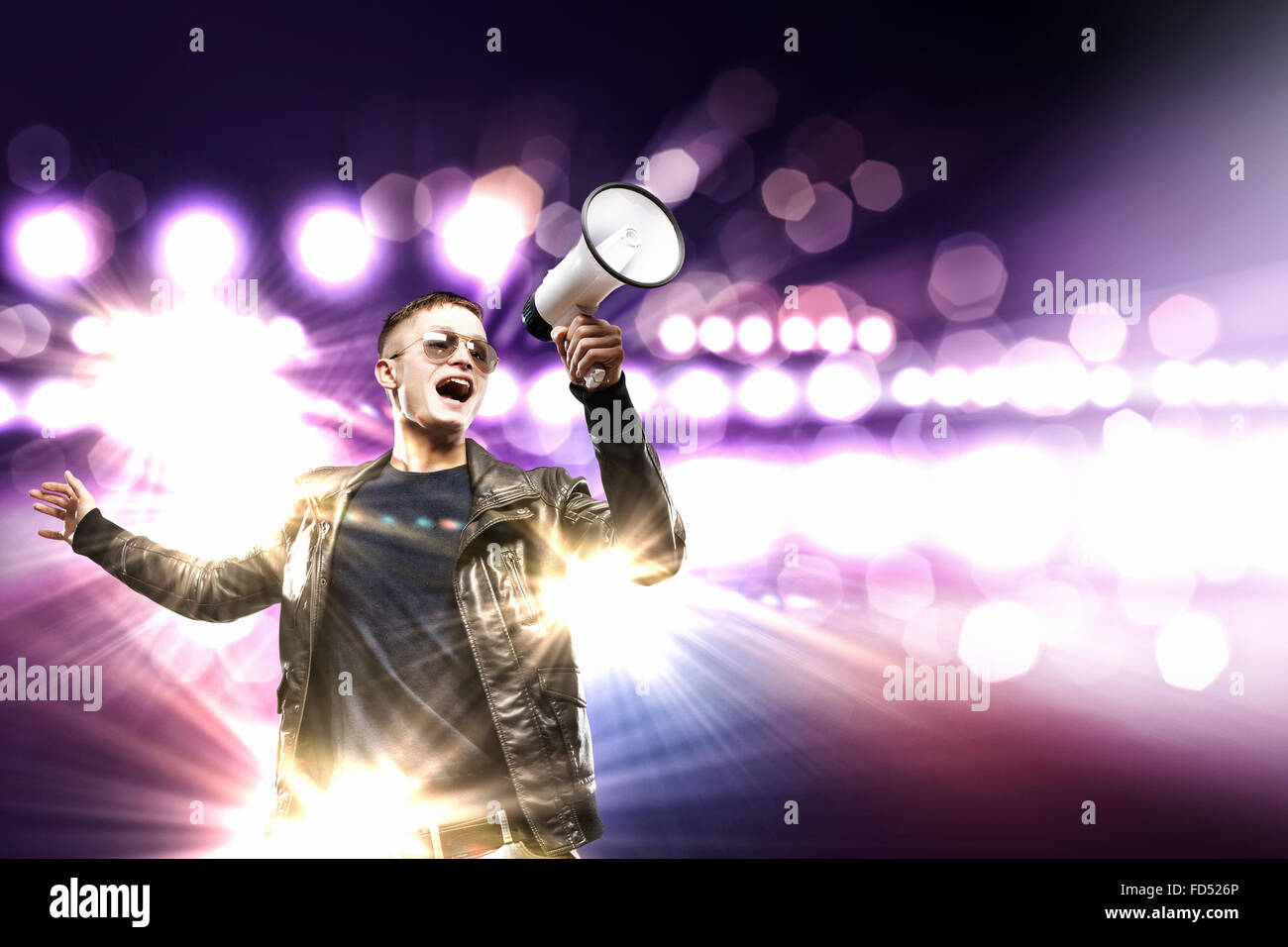 Image of young man rock musician screaming in megaphone Stock Photo - Alamy