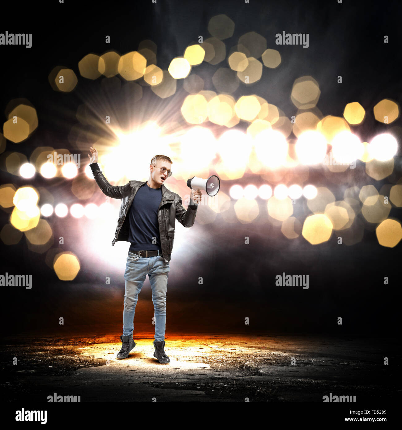 Image of young man rock musician screaming in megaphone Stock Photo - Alamy