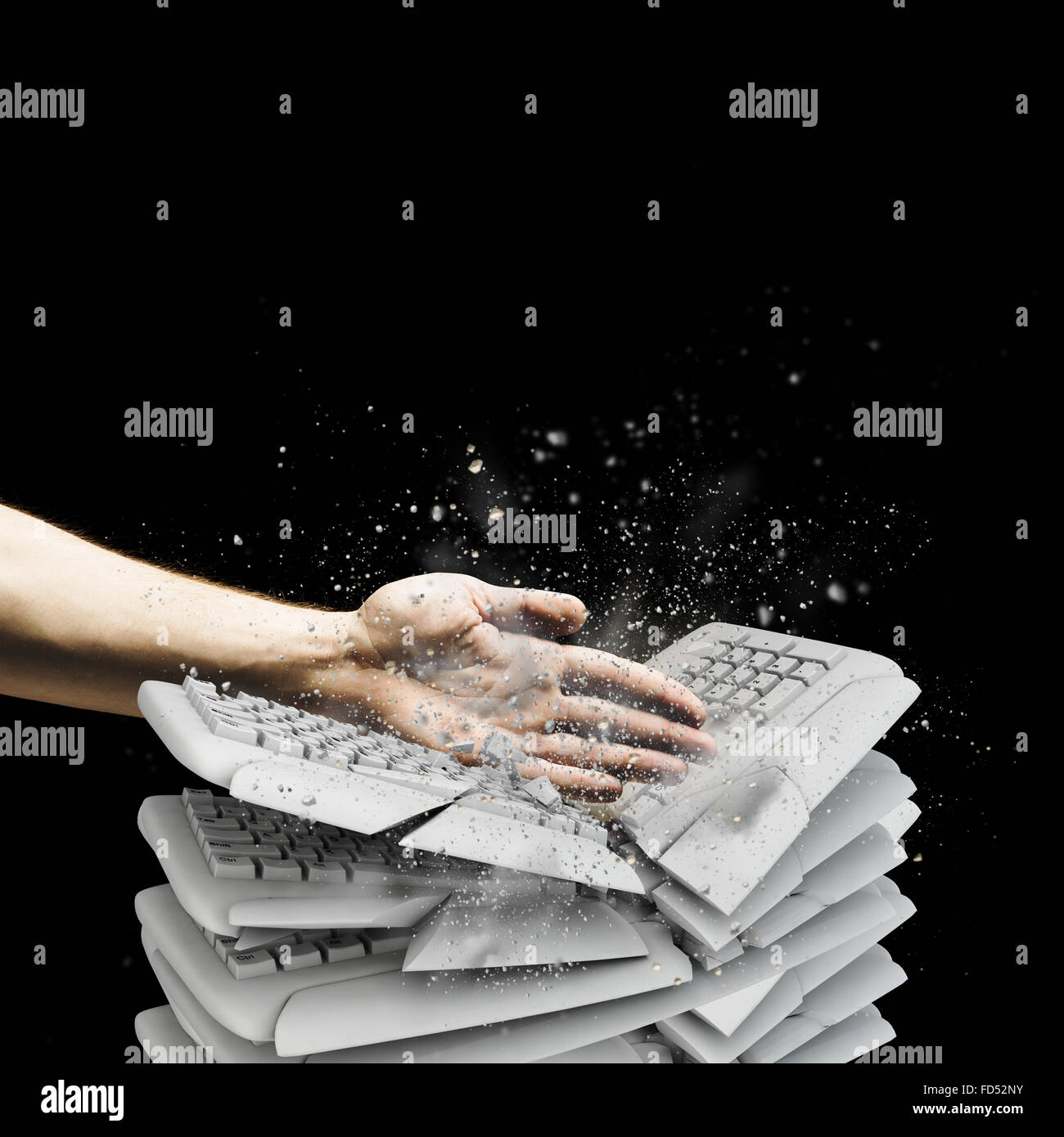 Image of human hand breaking pile of keyboards Stock Photo - Alamy