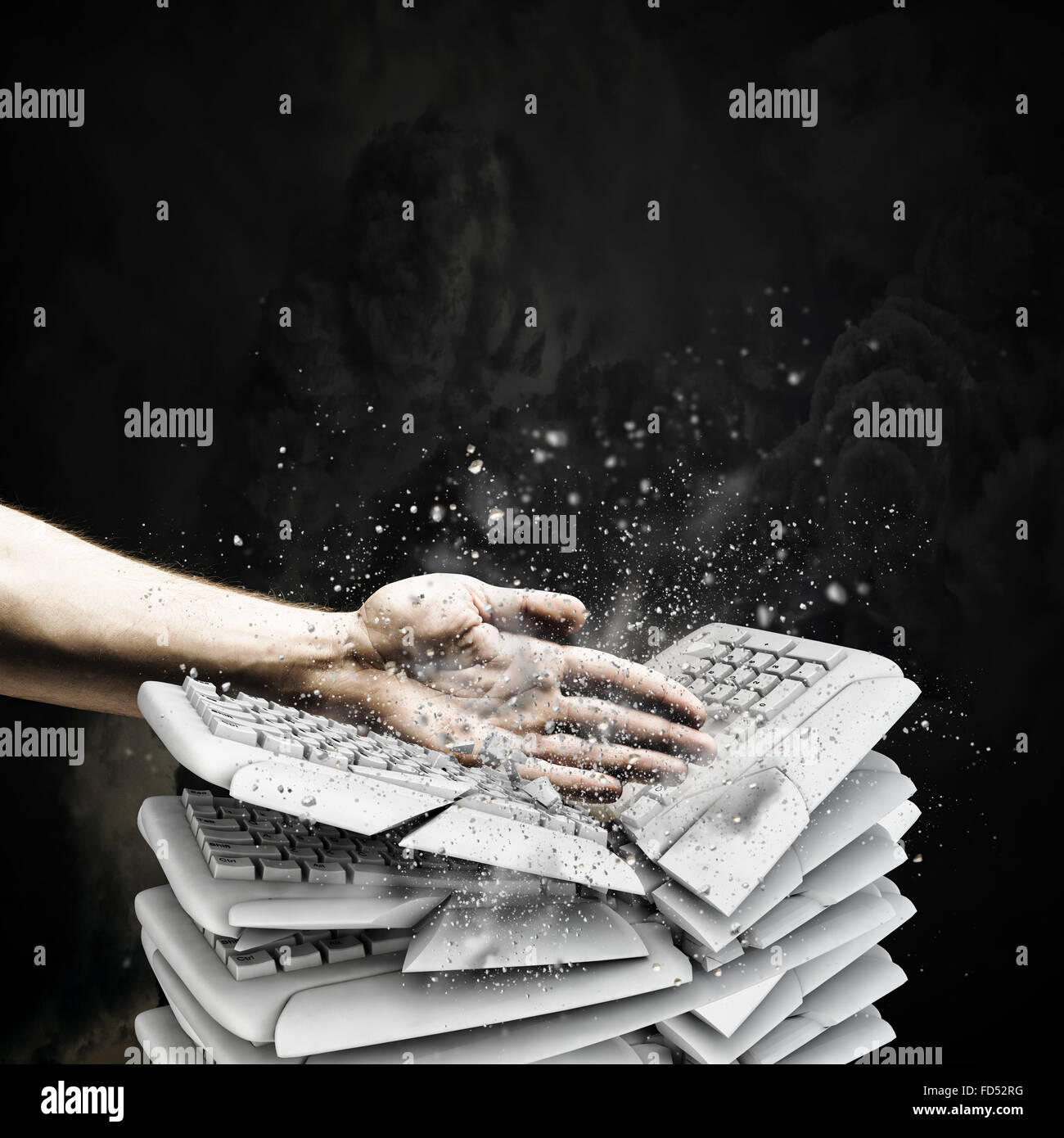 Image of human hand breaking pile of keyboards Stock Photo - Alamy