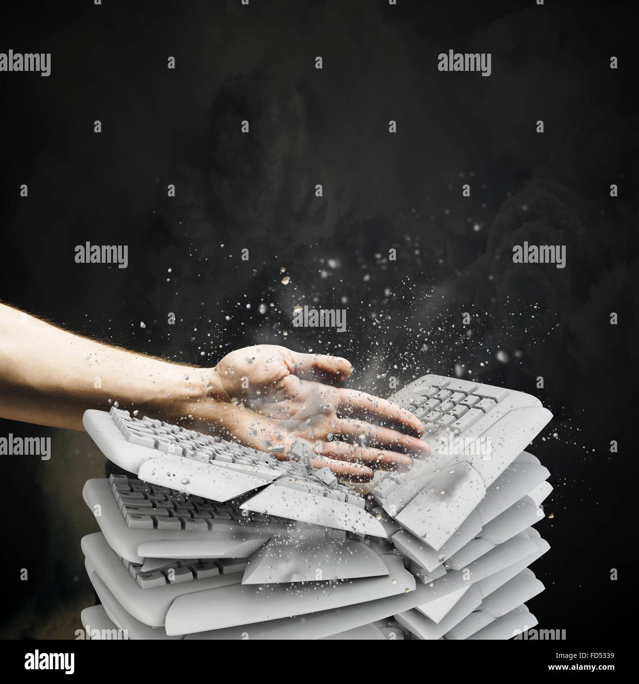 Image of human hand breaking pile of keyboards Stock Photo - Alamy