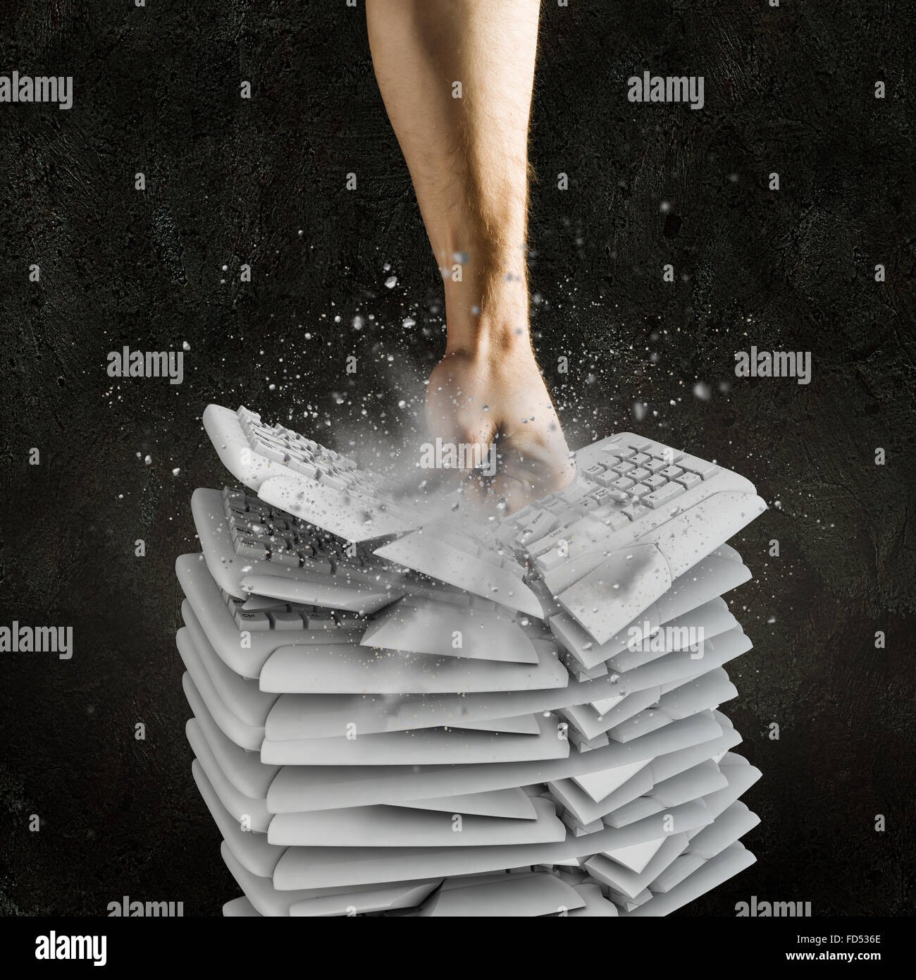 Image of human hand breaking pile of keyboards Stock Photo - Alamy
