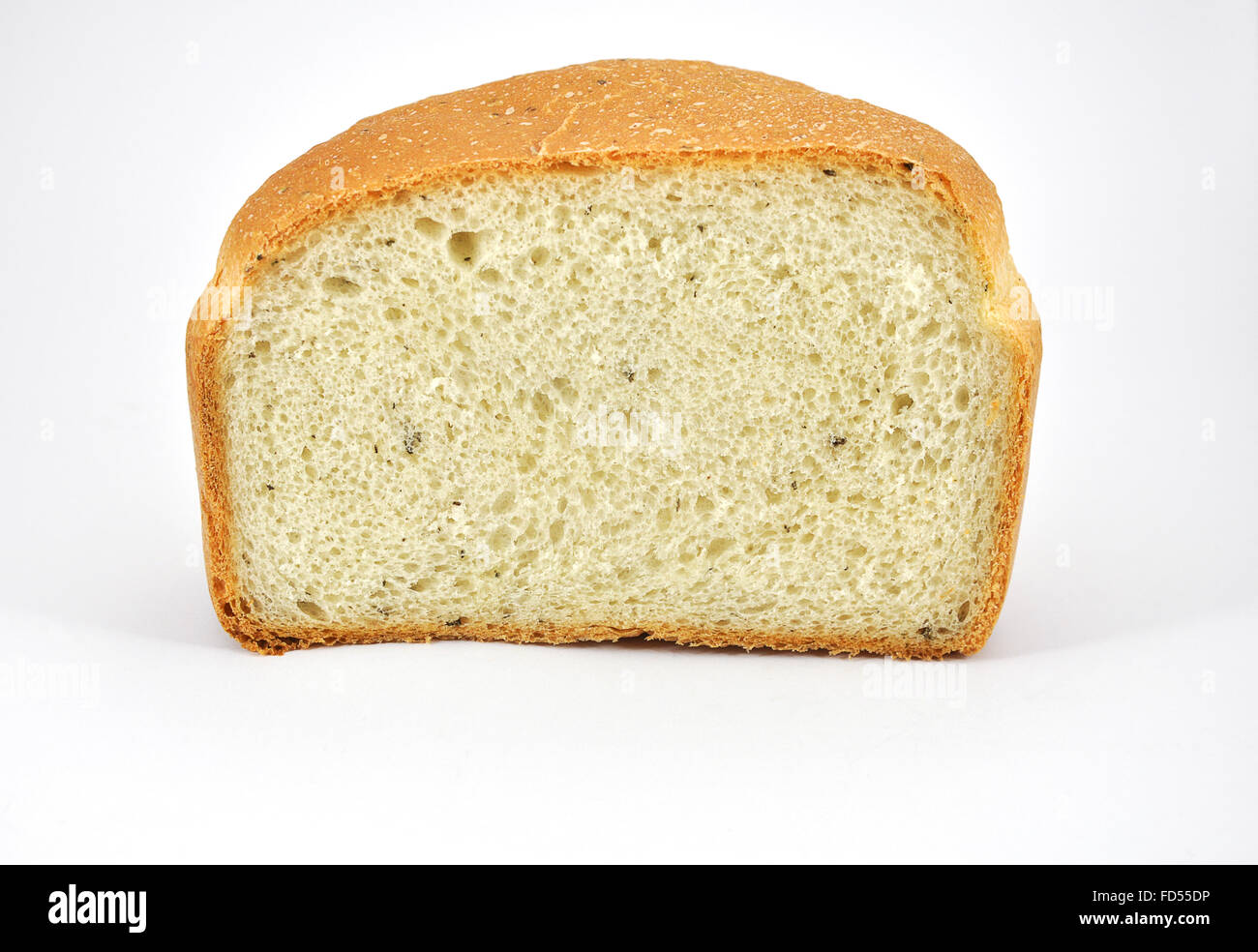 Half of round white bread with herbs and spices on a white background ...