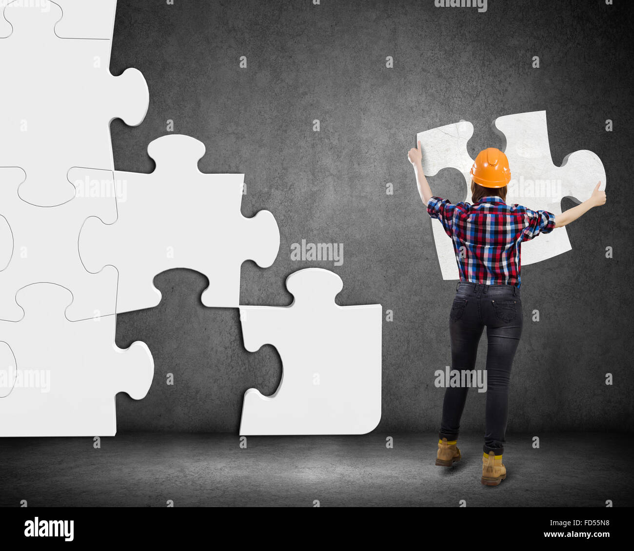 Image of young woman engineer connecting puzzle elements Stock Photo ...