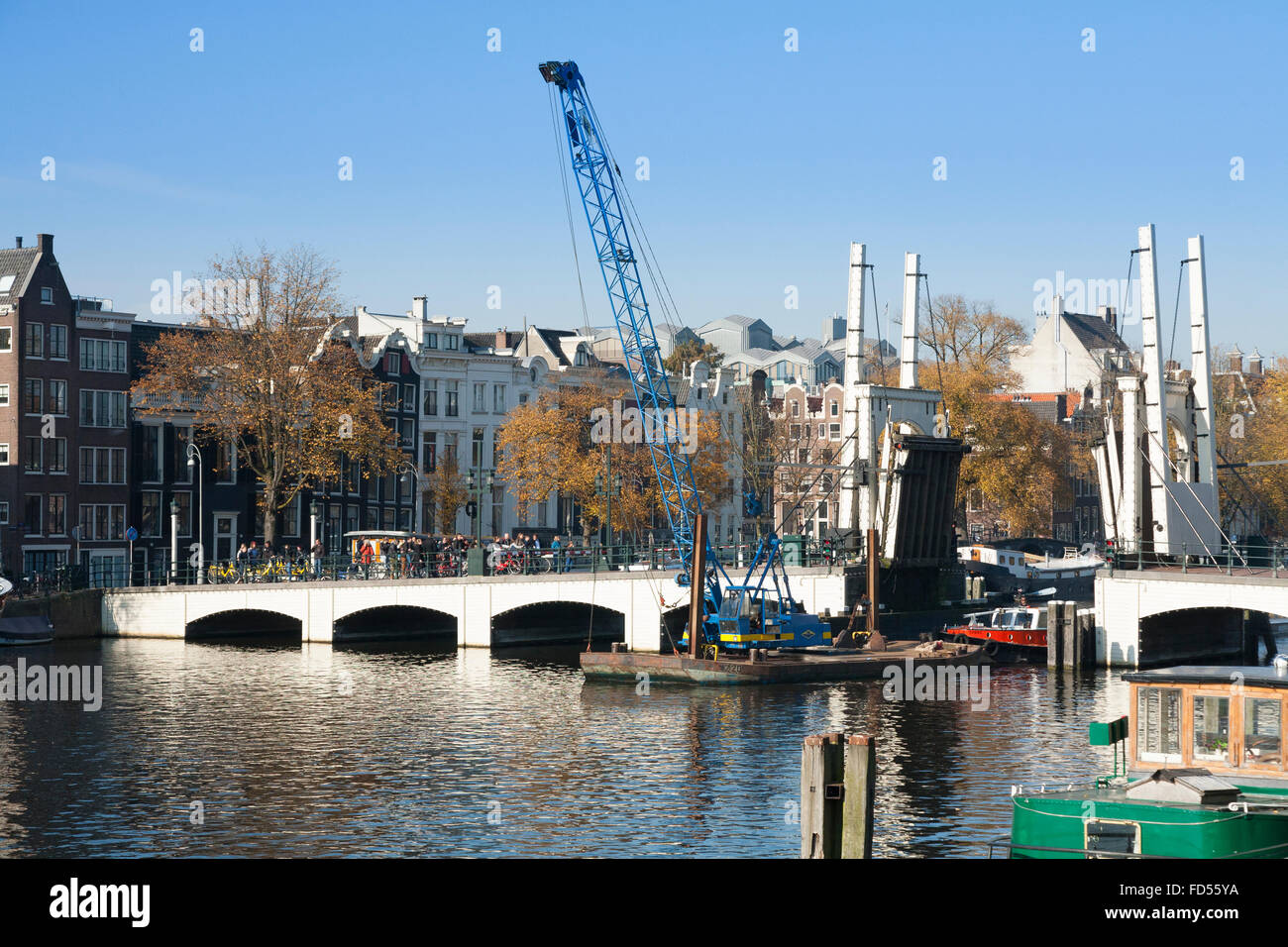 Boat / barge passes under the Magere Brug ('Skinny Bridge') in Dutch ...