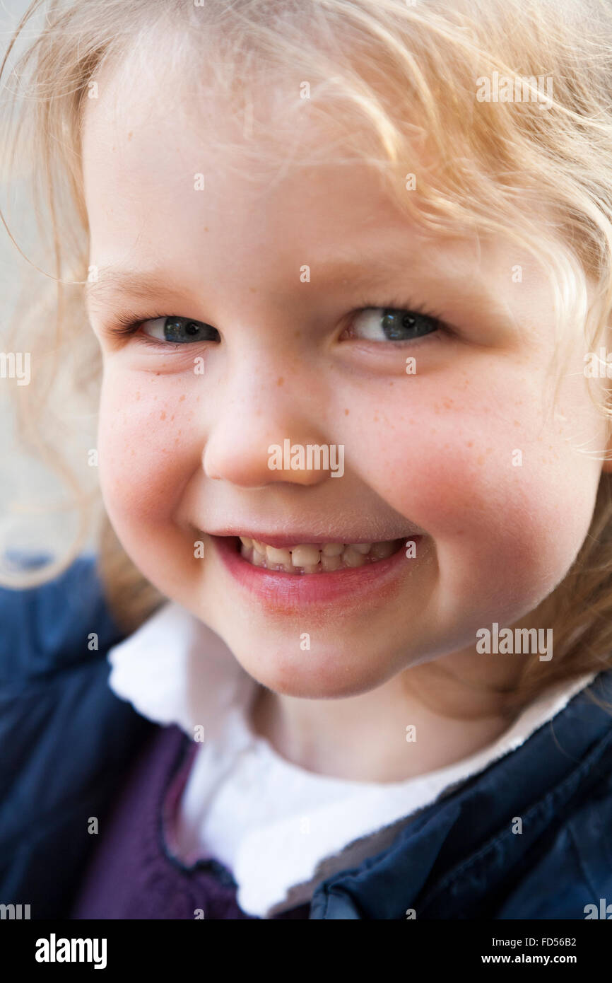 Face / portrait of a young girl age / aged 3 three year old, while she ...