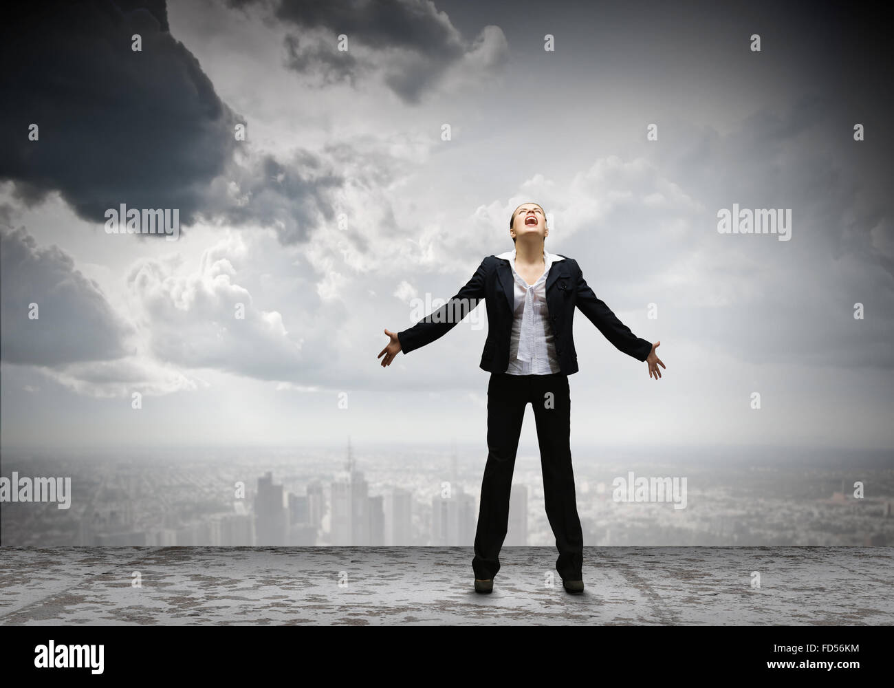 Image of businesswoman on top of building screaming Stock Photo - Alamy