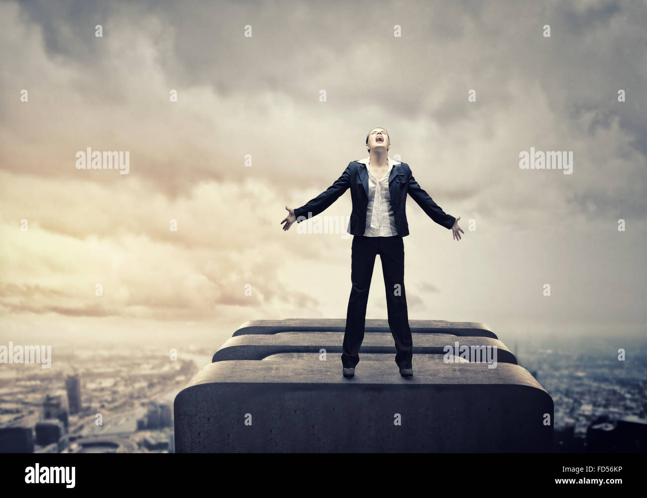 Image of businesswoman on top of building screaming Stock Photo - Alamy
