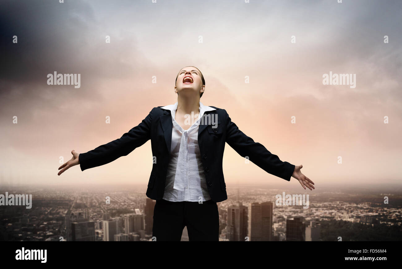 Image of businesswoman on top of building screaming Stock Photo - Alamy