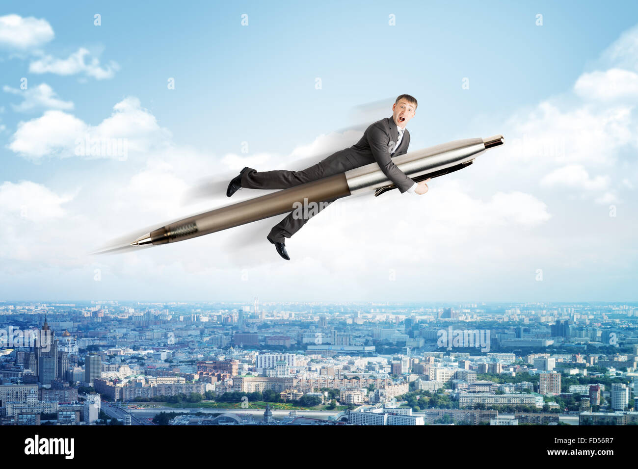 Businessman flying on big pen Stock Photo - Alamy