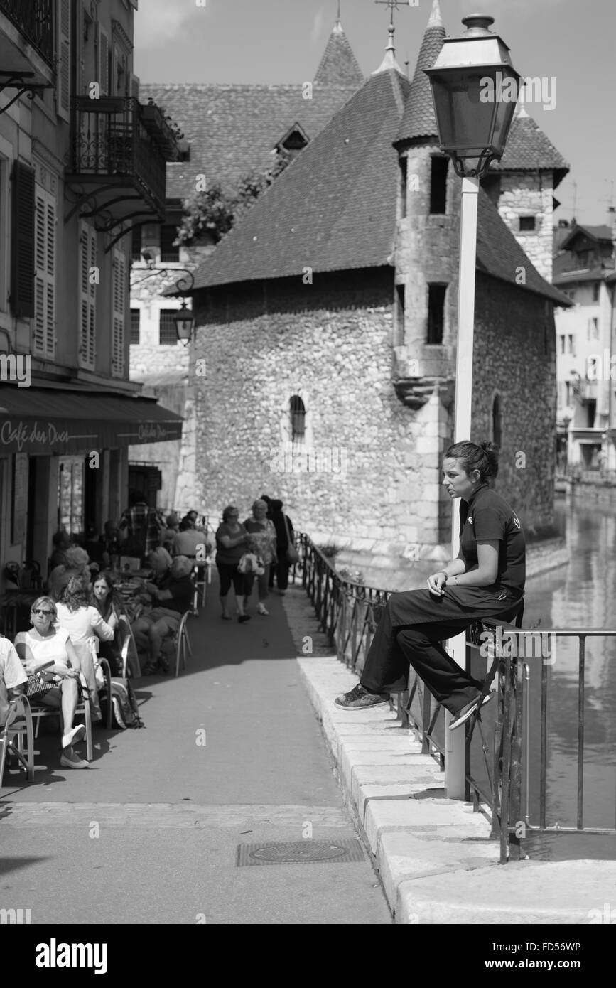Cigarette break of a young waitress in front of the Palais de l'Isle at ...