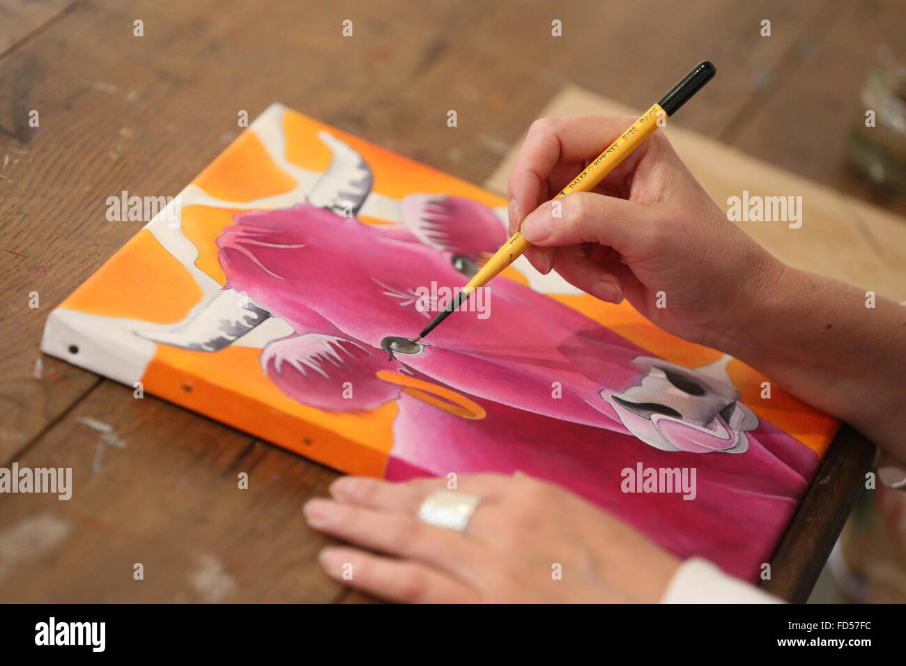 French artist Muriel Mollier Pierret painting in her gallery Stock ...