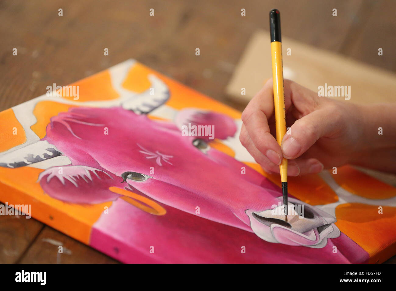 French artist Muriel Mollier Pierret painting in her gallery Stock ...