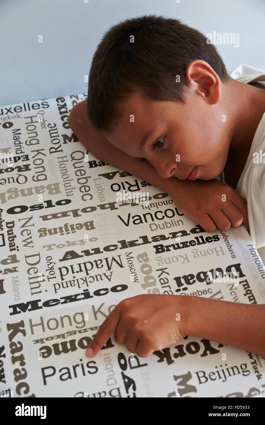 Boy pointing at the name of his hometown Stock Photo - Alamy
