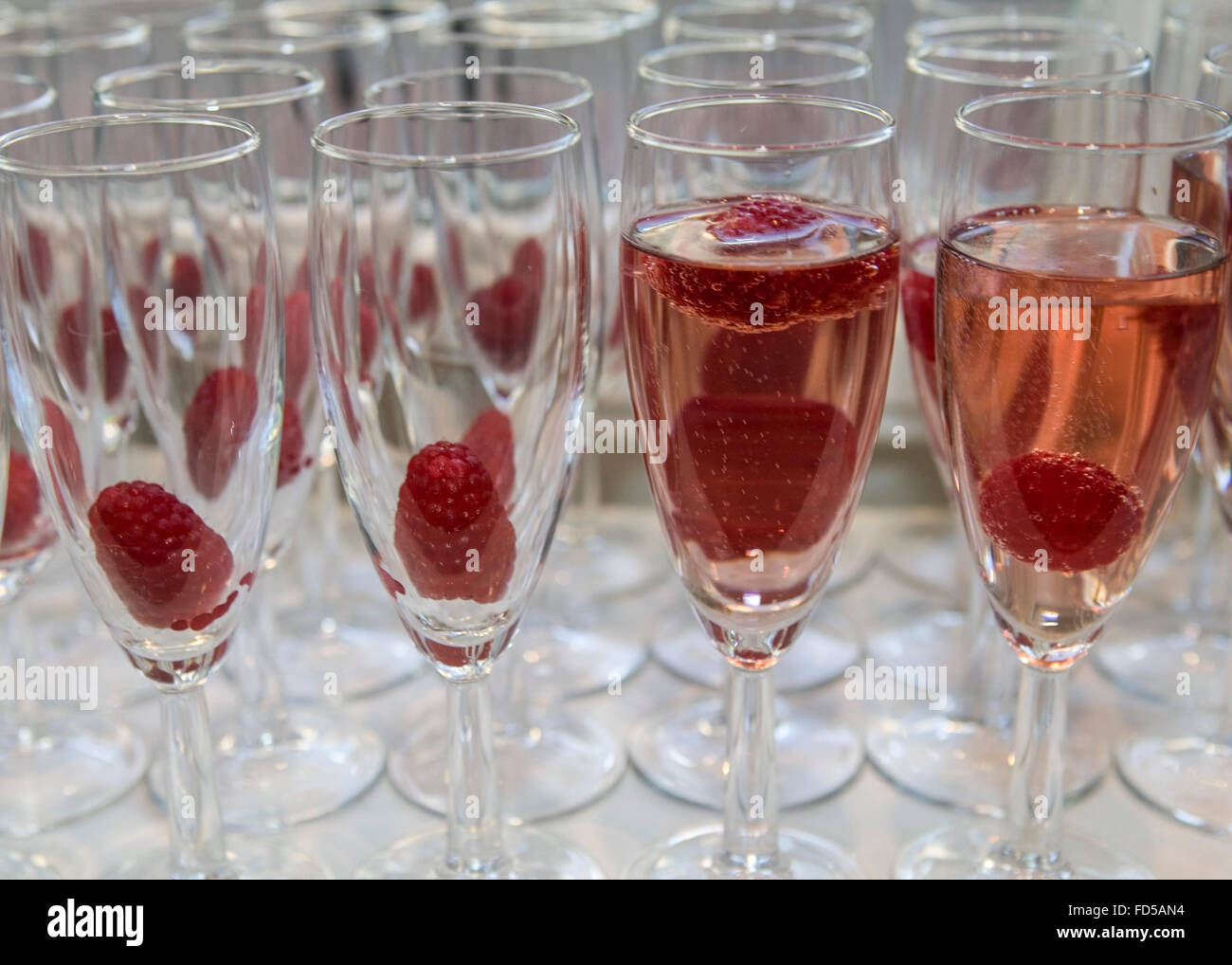 Pink champagne with raspberries Stock Photo - Alamy