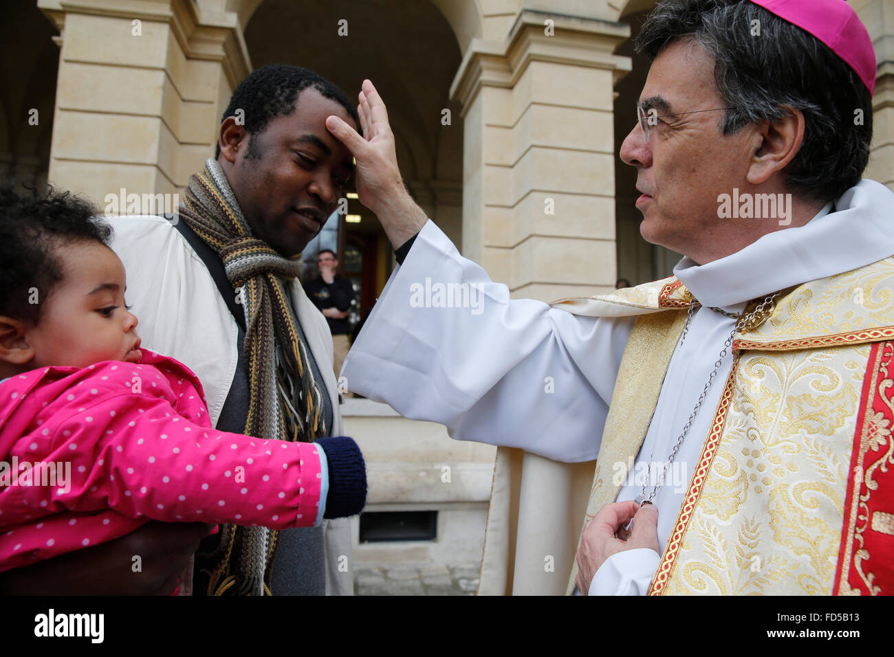Catholic bishop blessing a father Stock Photo - Alamy
