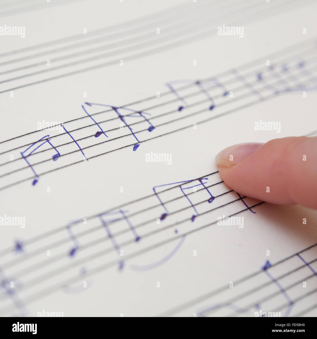 Hand with pen and music sheet Stock Photo - Alamy