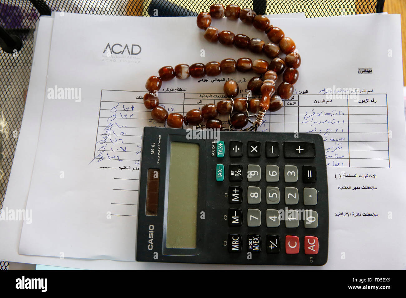 ACAD office in Tulkarem. Calculator and prayer beads Stock Photo - Alamy