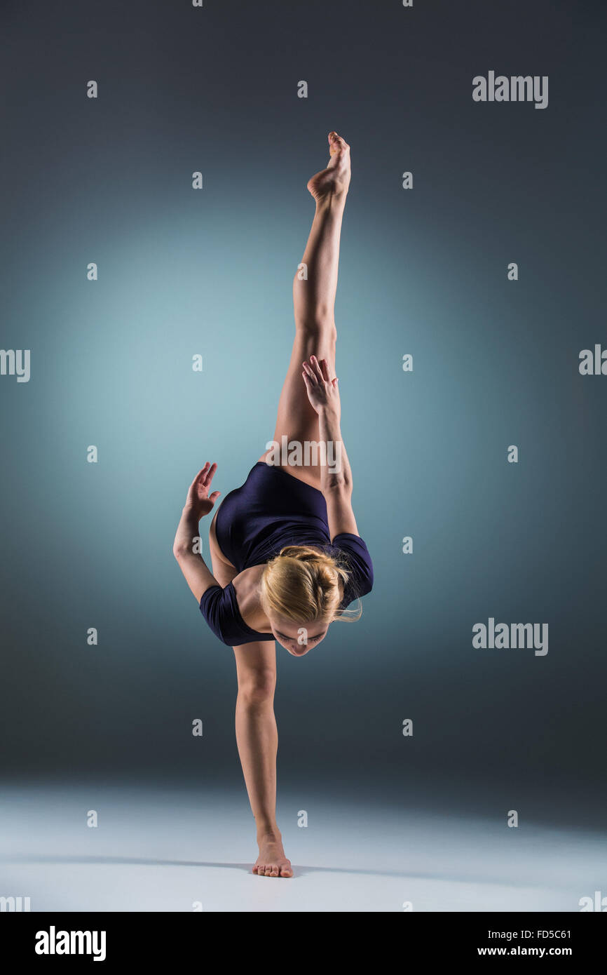 Young beautiful modern style dancer posing on a studio background Stock ...