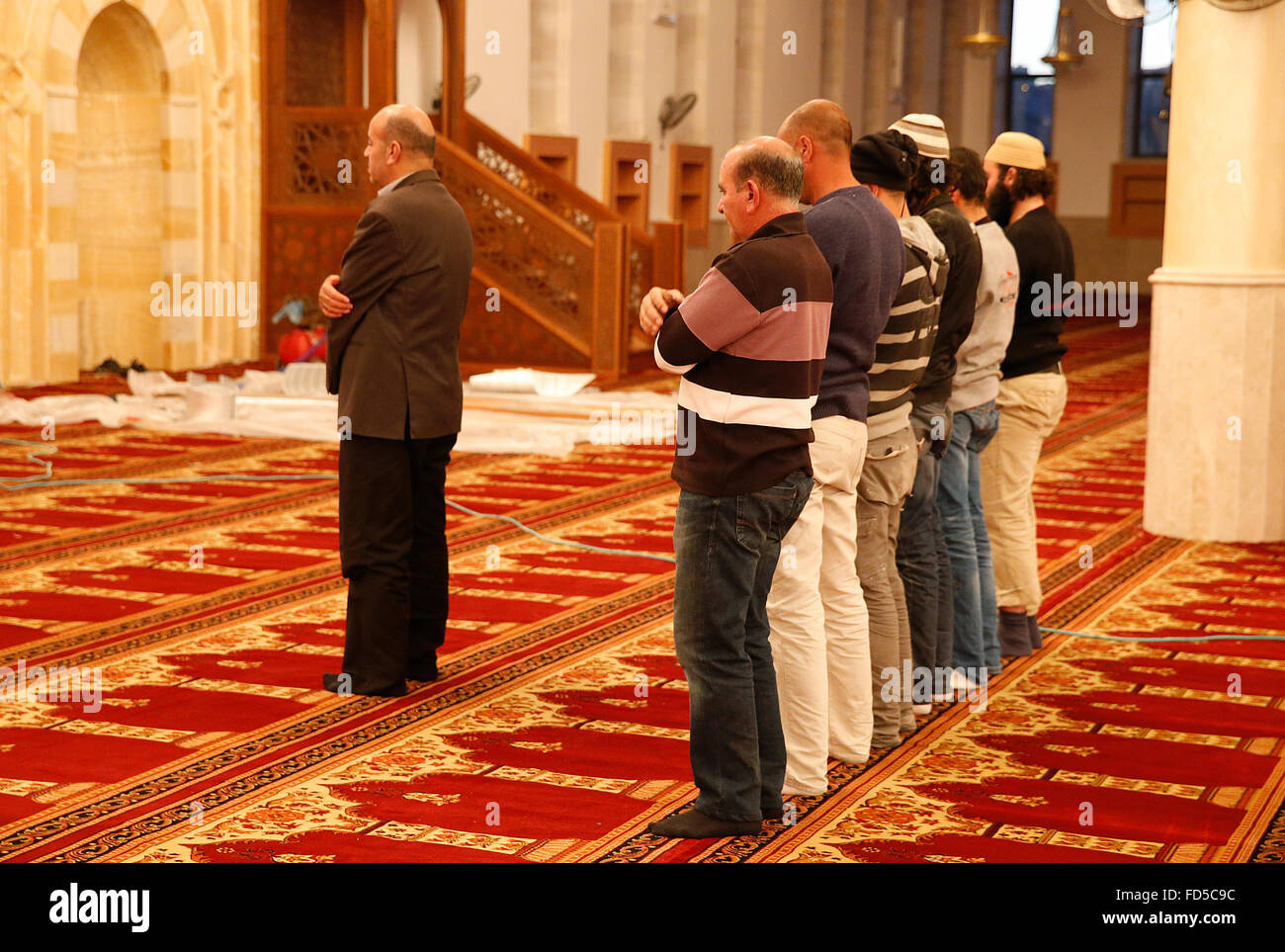 Workers praying during the construction of a new mosque in Al-Eizariya ...