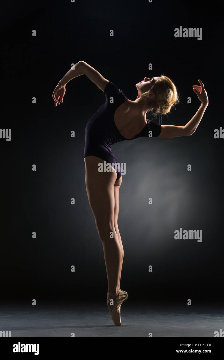 Young beautiful modern style dancer posing on a studio background Stock ...