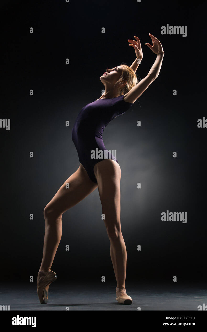 Young beautiful modern style dancer posing on a studio background Stock ...