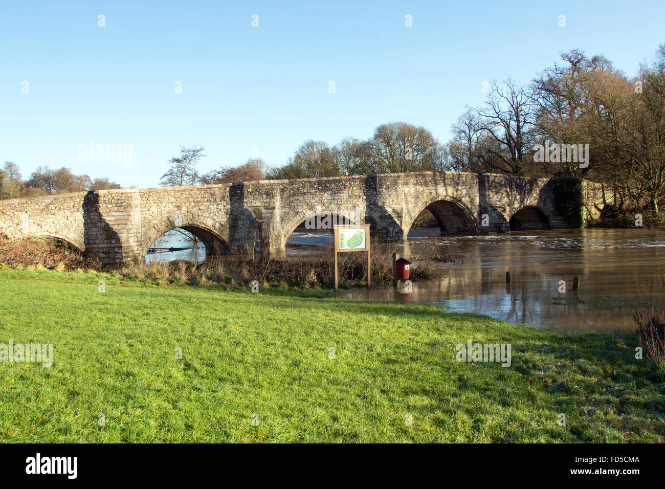 In winter sunshine following heavy rain the river Medway runs high and ...
