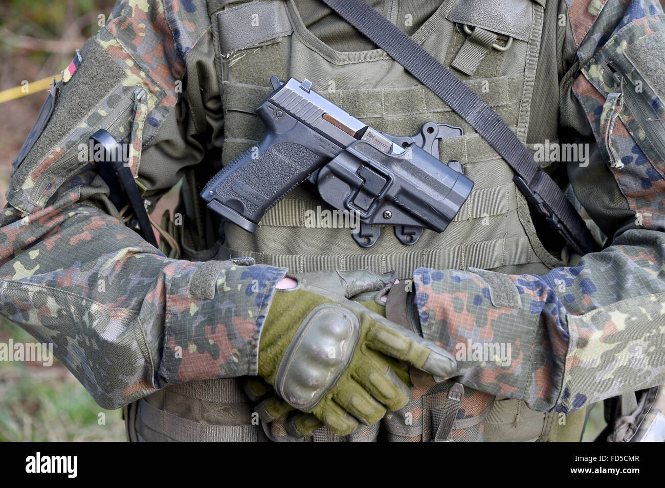 Eutin, Germany. 28th Jan, 2016. A "P8" pistol against a soldier's chest ...