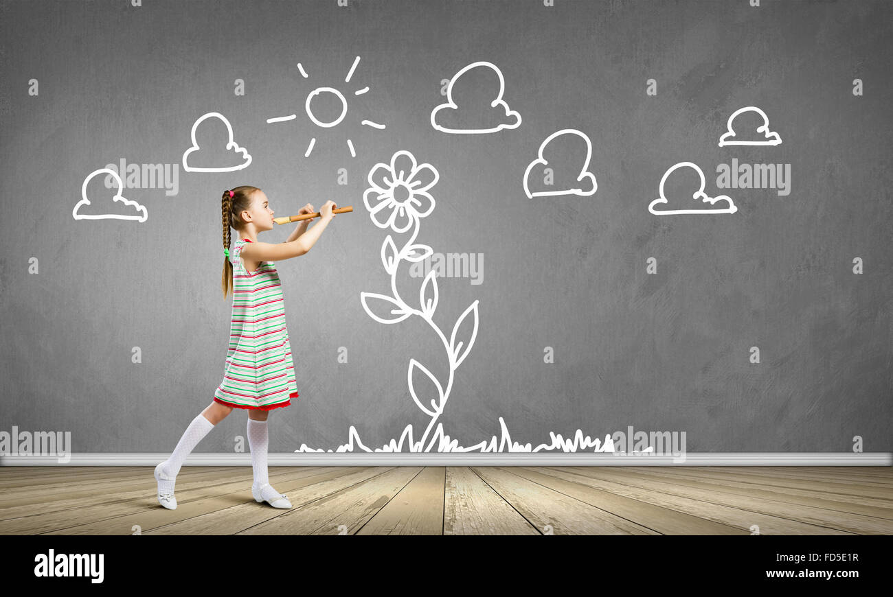 Image of little cute girl playing on flute Stock Photo - Alamy
