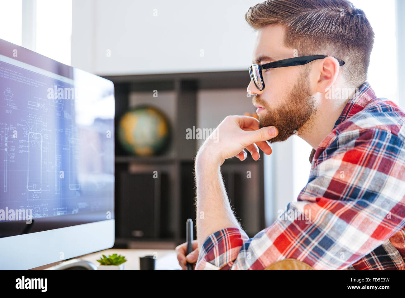 Profile Of Concentrated Bearded Man In Glasses Sitting And Drawing