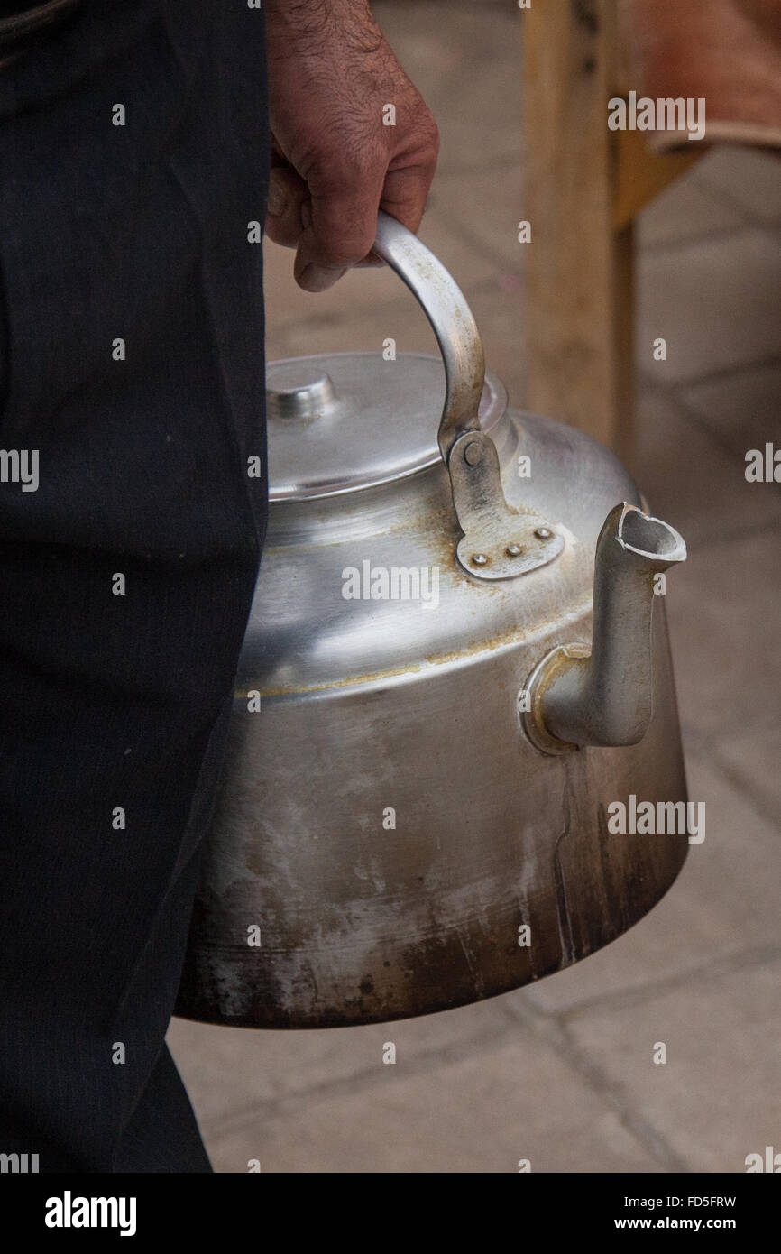 Hand holding teapot handle hi-res stock photography and images - Alamy