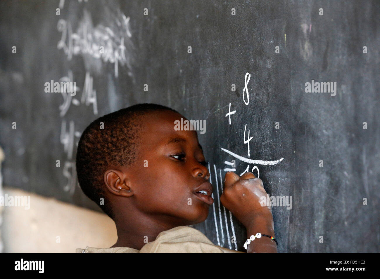 African primary school. Pupil at the blackboard. Mathematics class ...
