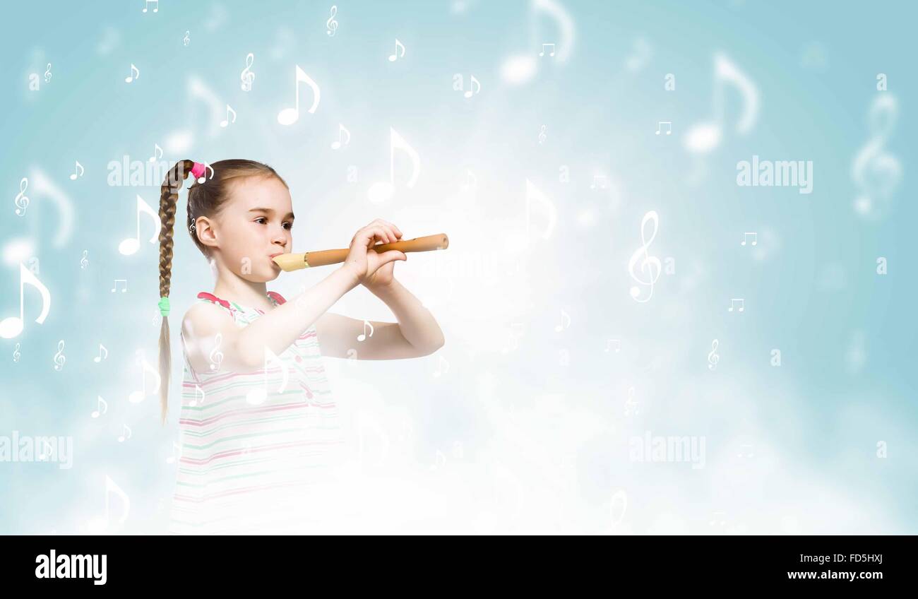 Image of little cute girl playing on flute Stock Photo - Alamy