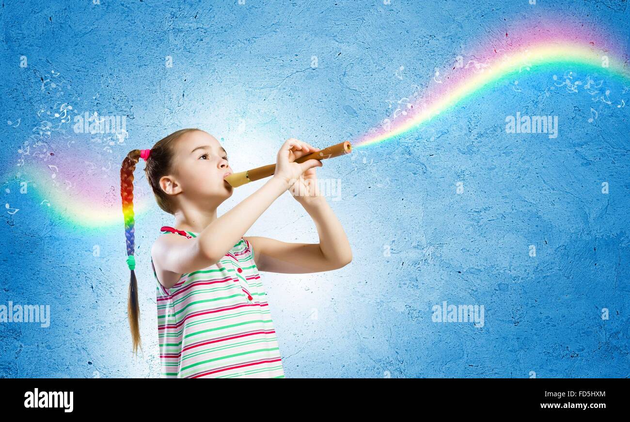 Image of little cute girl playing on flute Stock Photo - Alamy
