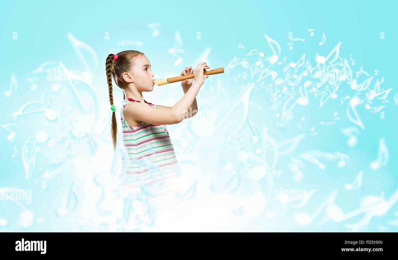 Image of little cute girl playing on flute Stock Photo - Alamy