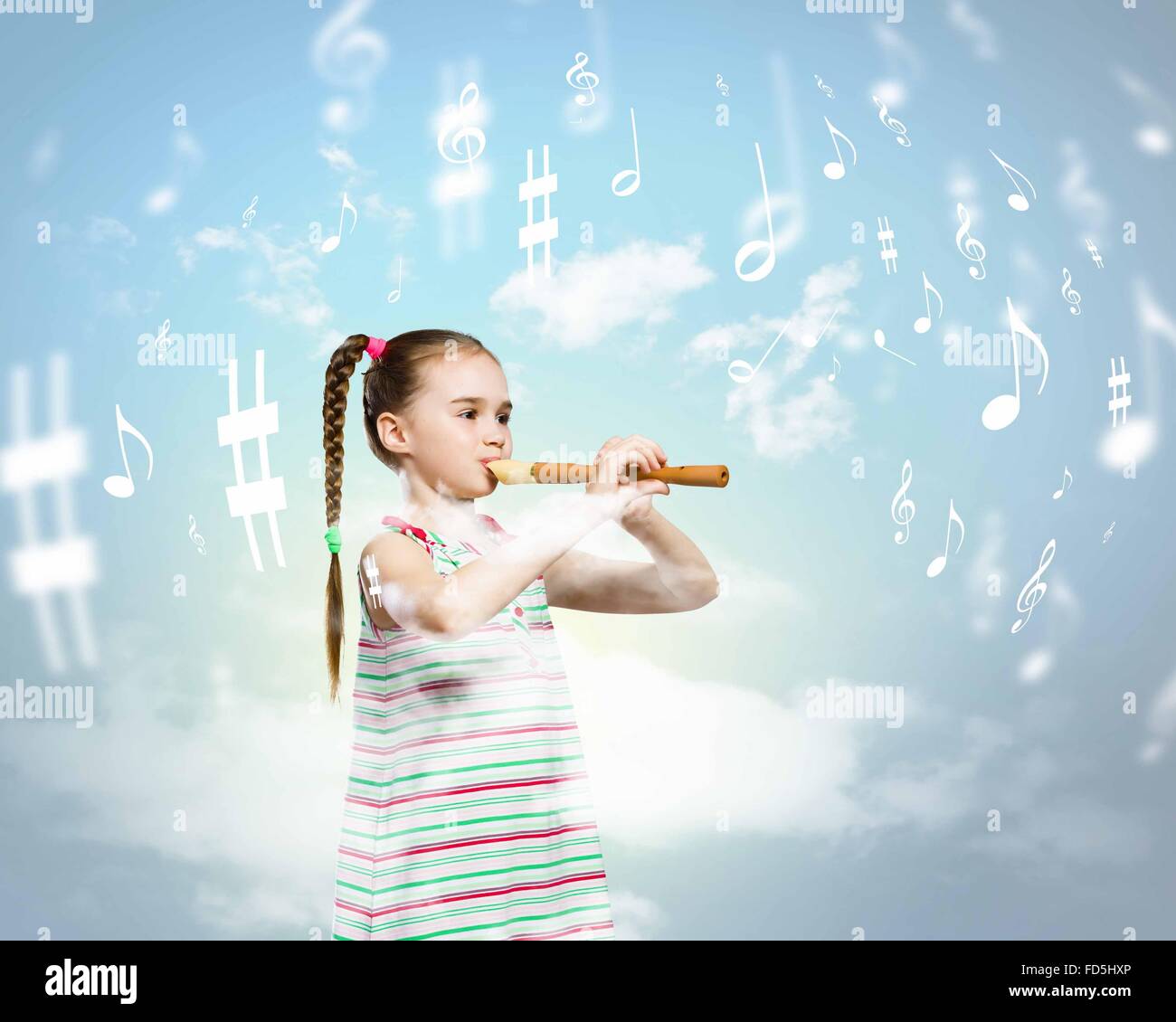 Image of little cute girl playing on flute Stock Photo - Alamy