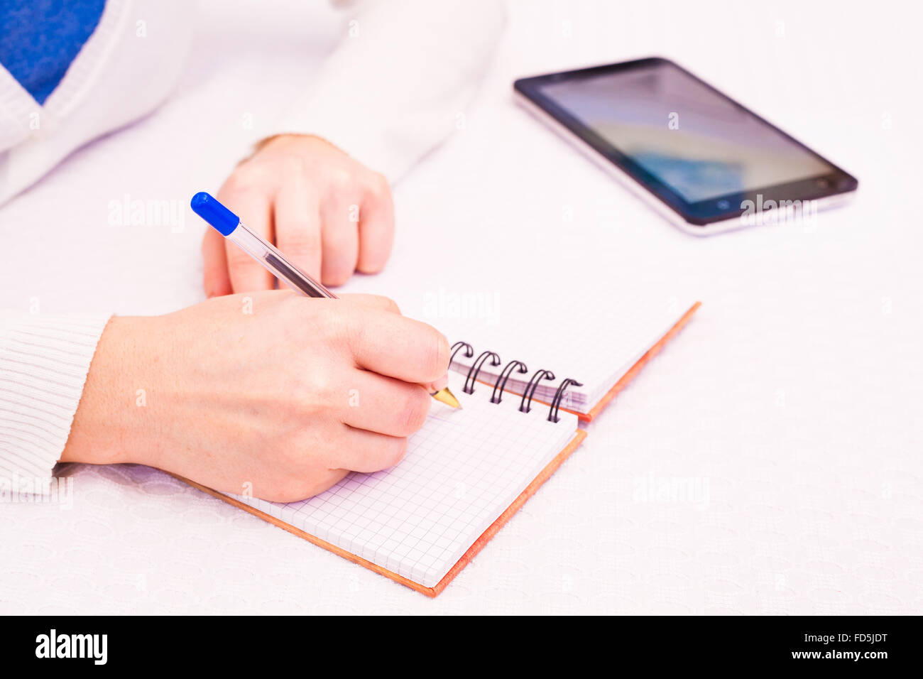 Business Woman Writing with pen in notepad Stock Photo - Alamy
