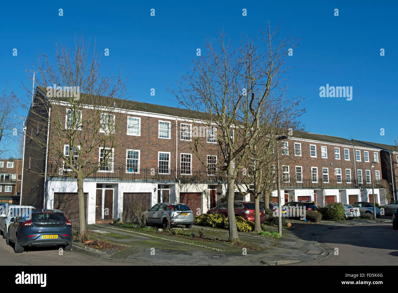 row of modern townhouses forming part of broom park, teddington ...