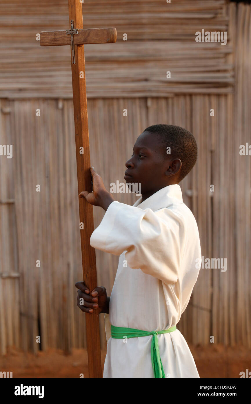 African altar boy carrying a cross Stock Photo - Alamy