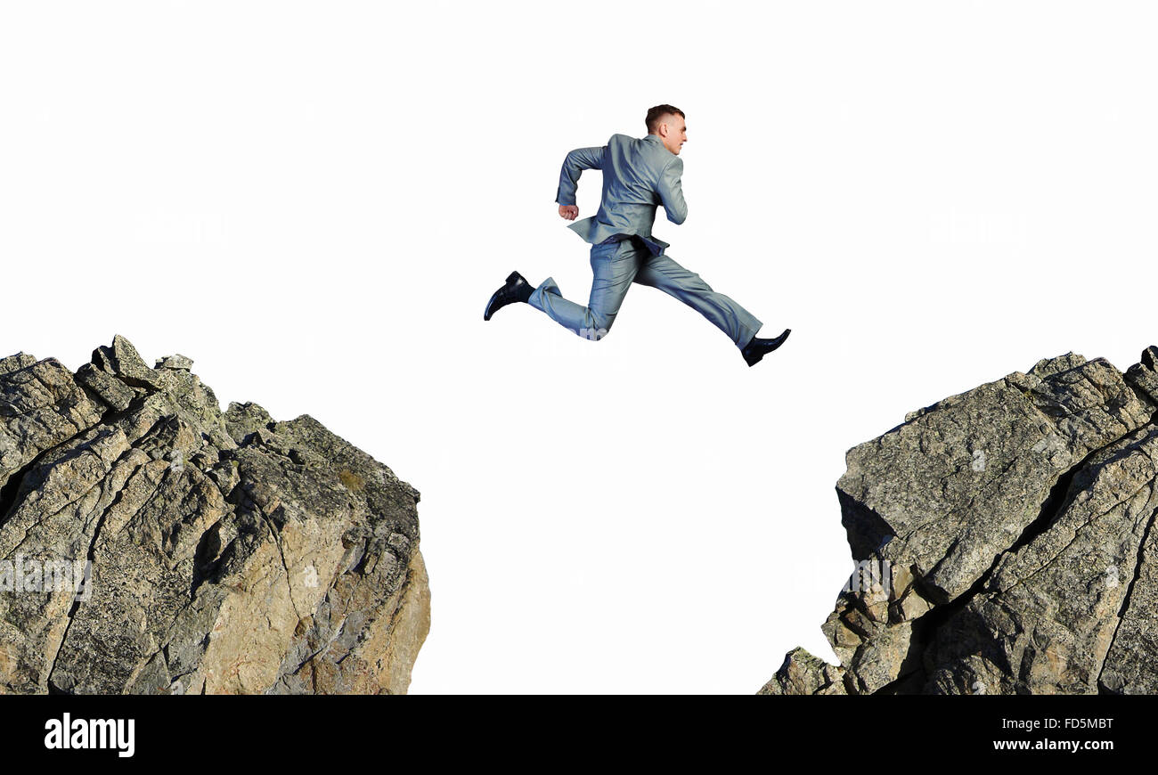 Image of young businessman jumping over gap Stock Photo - Alamy