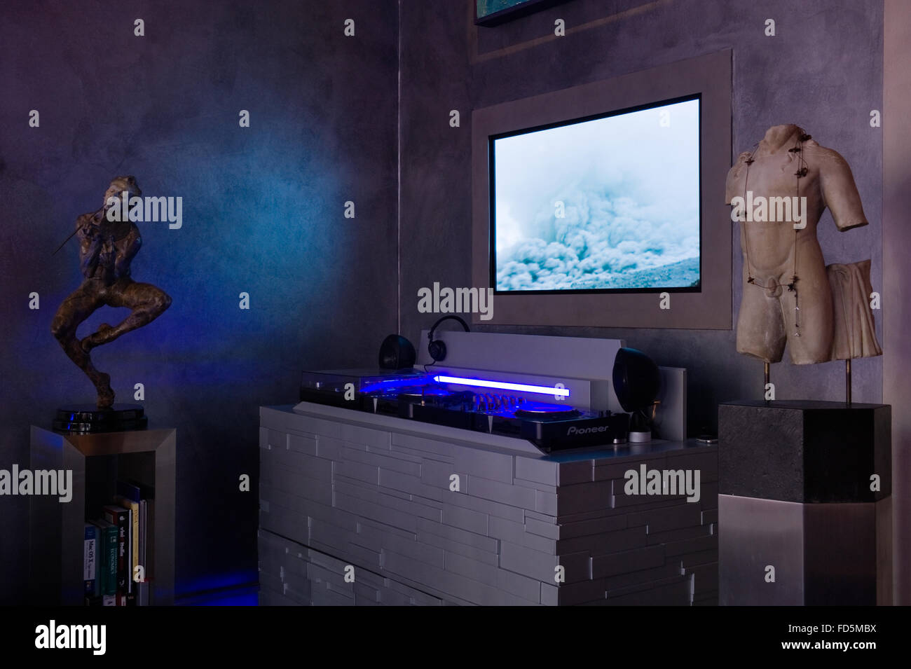 Entertainment suite, screen with mixing desk in neon lit London ...