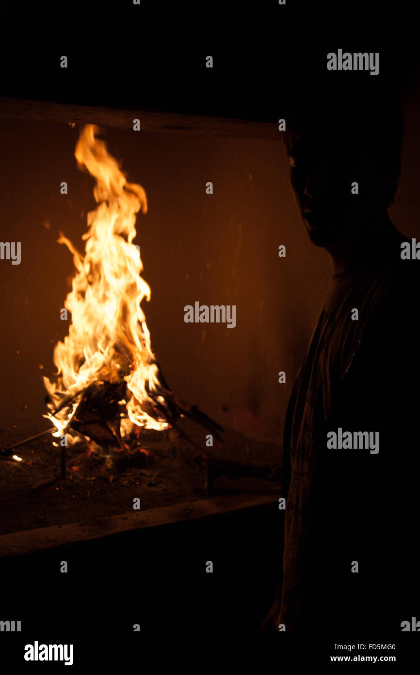 Man Standing Near Bonfire At Night Stock Photo - Alamy