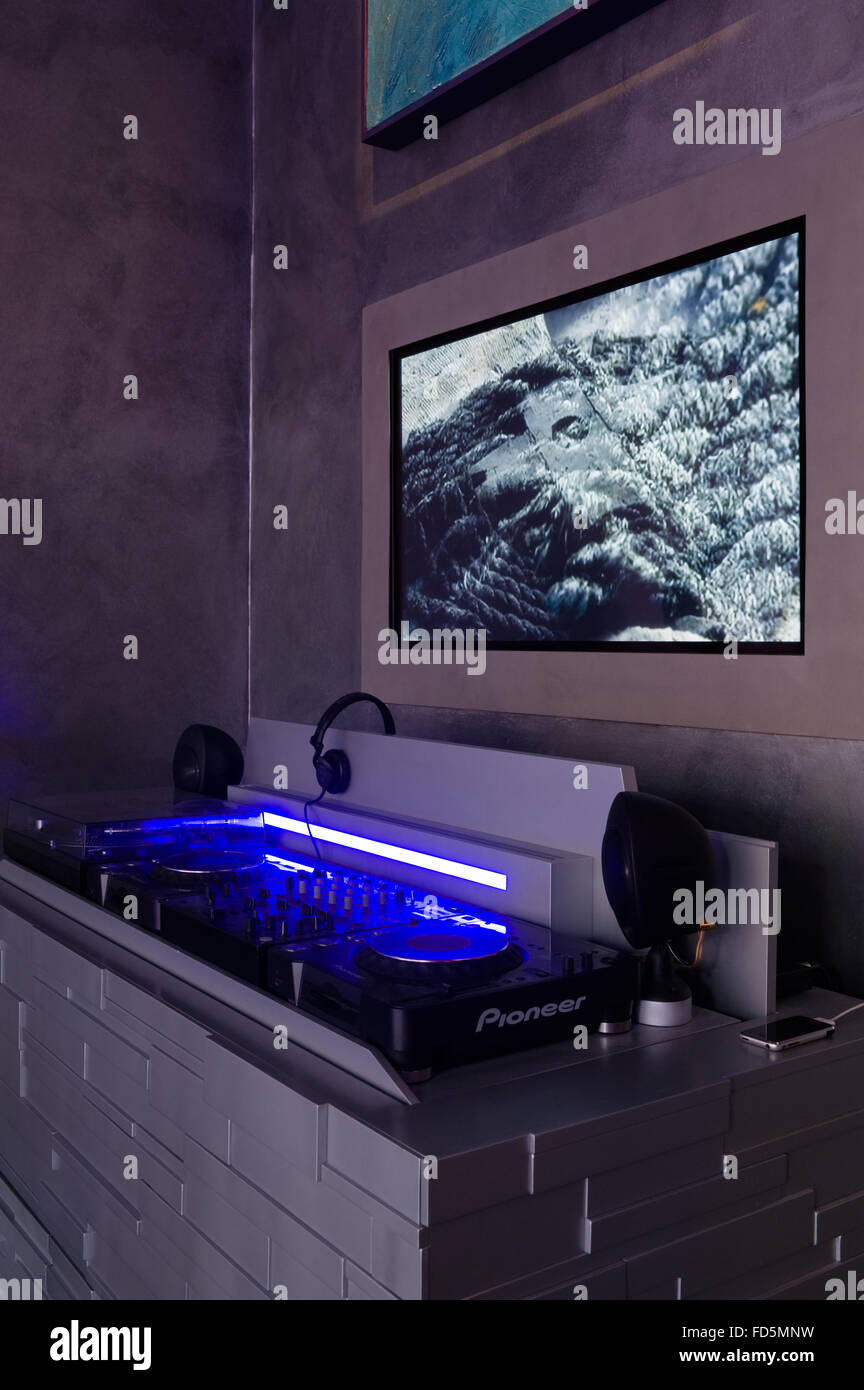 Entertainment suite, screen with mixing desk in neon lit London ...