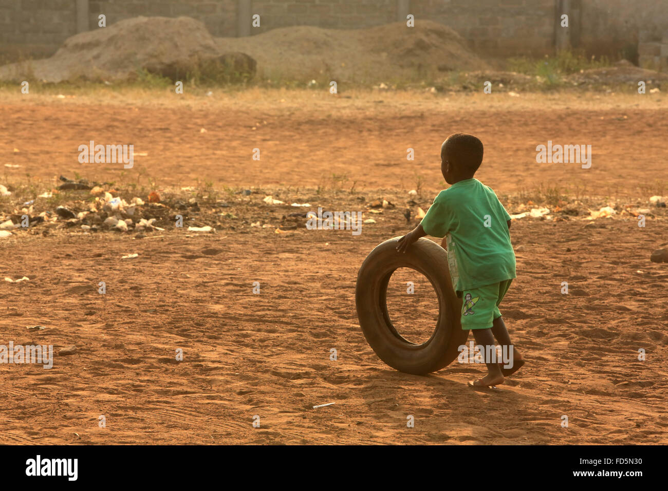 African Child playing with a tire Stock Photo - Alamy